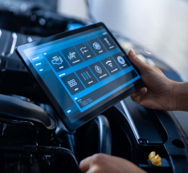 Technician_holding_tablet_close_up_inspecting_car_engine - River City ...